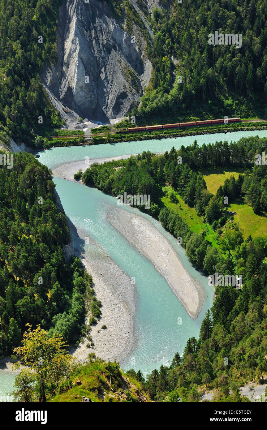 Train of the Rhaetian Railway on the riverbanks of the Vorderrhein ...