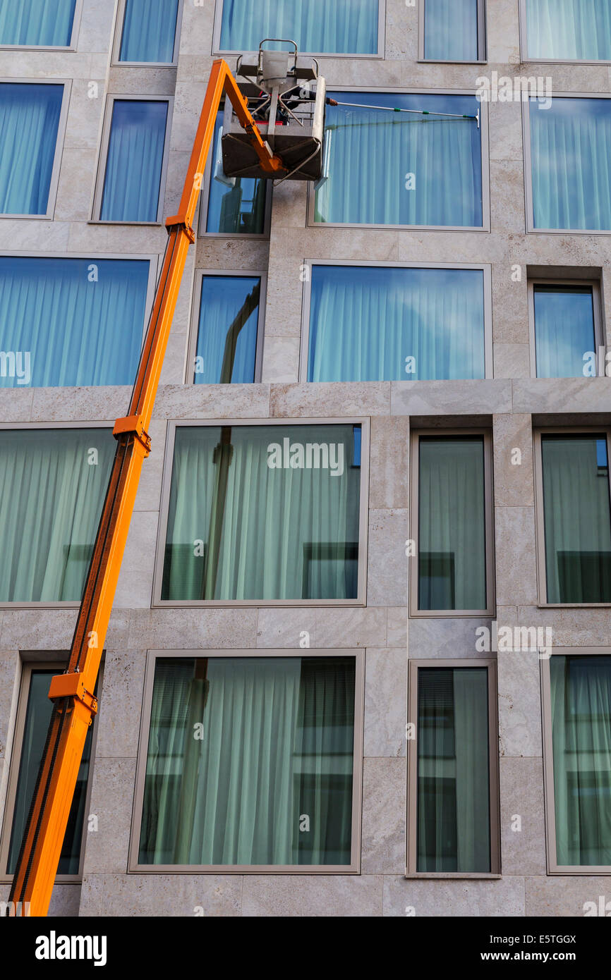 Window cleaner cleaning the windows of a hotel, Berlin, Germany Stock ...