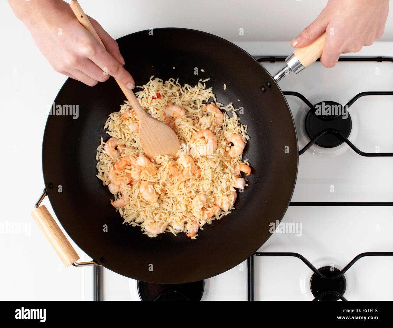 STIR FRYING THAI RICE AND PRAWNS IN WOK Stock Photo - Alamy