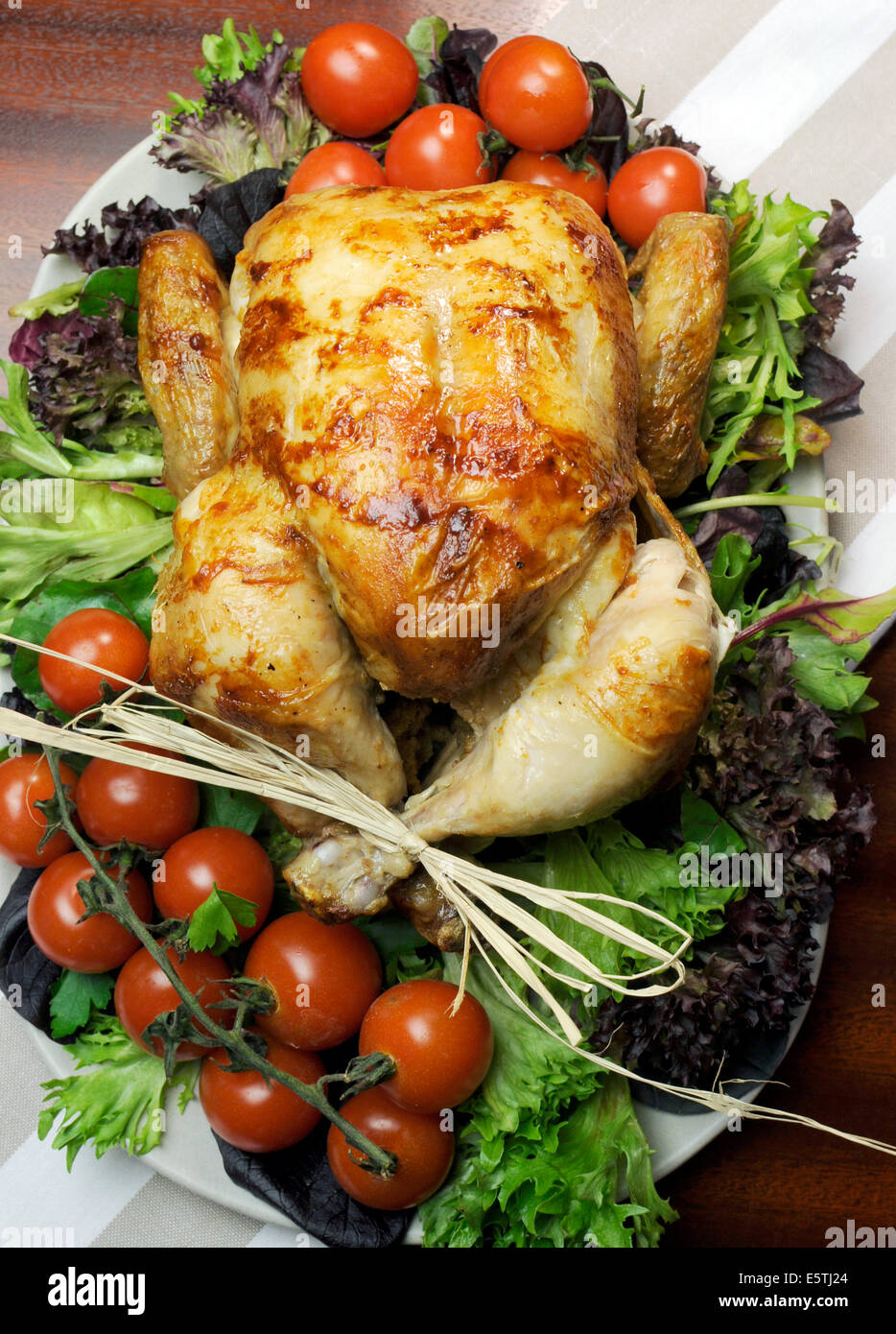Platter of delicious roast chicken turkey with salad greens and red ...