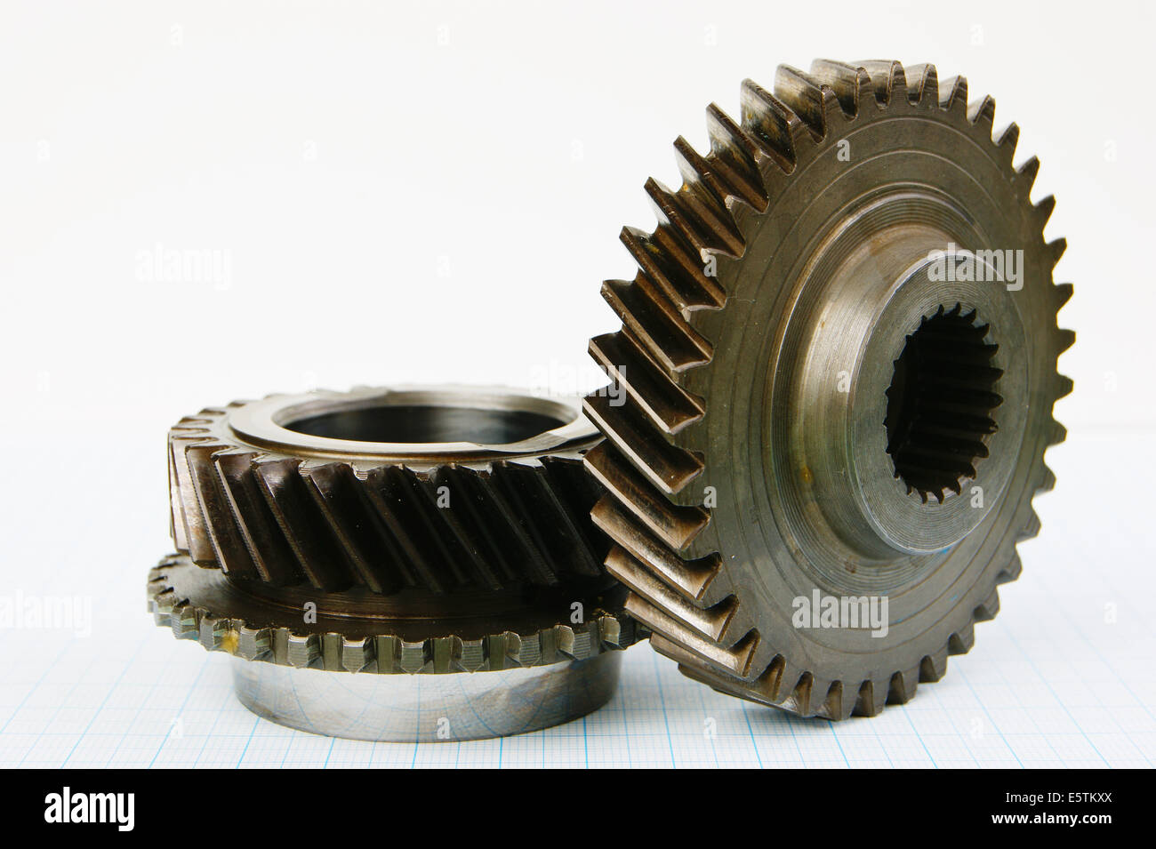 Two gears on graph paper Stock Photo - Alamy