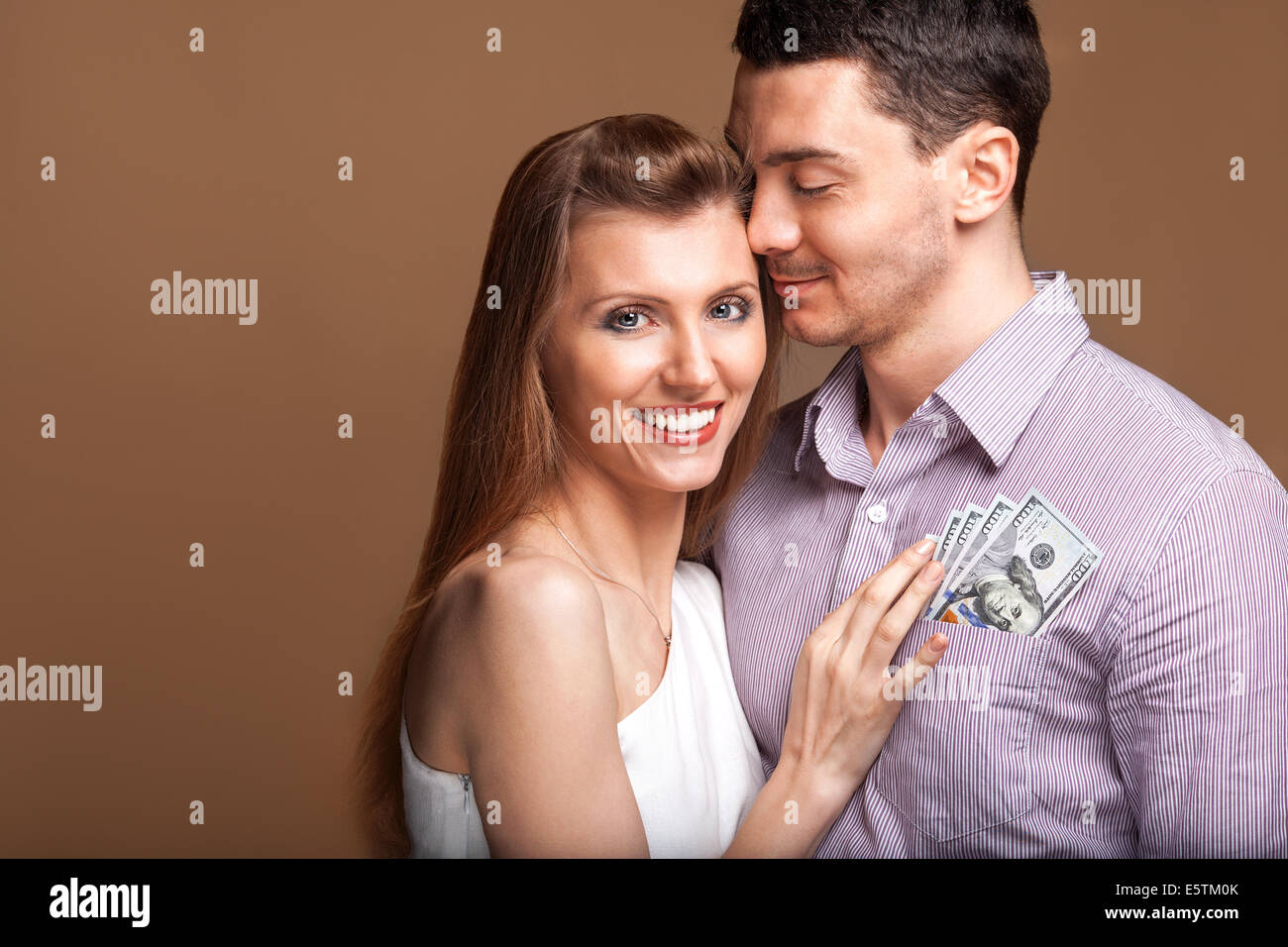 Fashion beautiful couple in love holding money the family budget ...