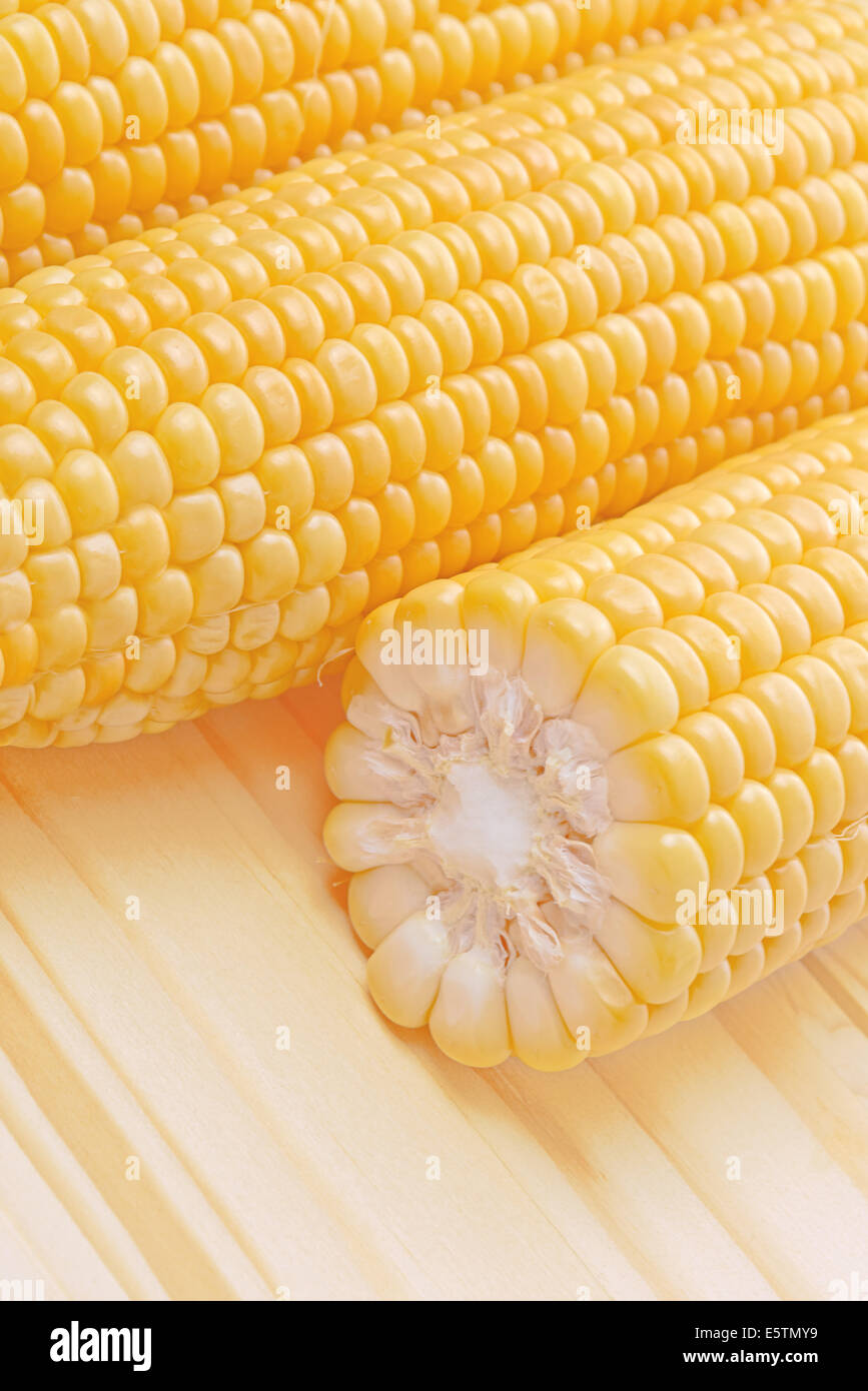 Corn Cob with golden seed split in half on wooden table Stock Photo - Alamy