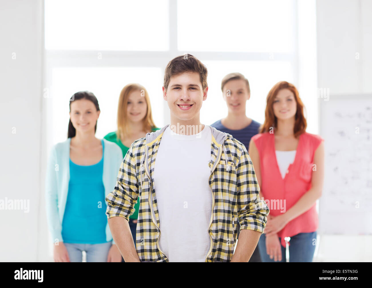 smiling male student with group of classmates Stock Photo - Alamy