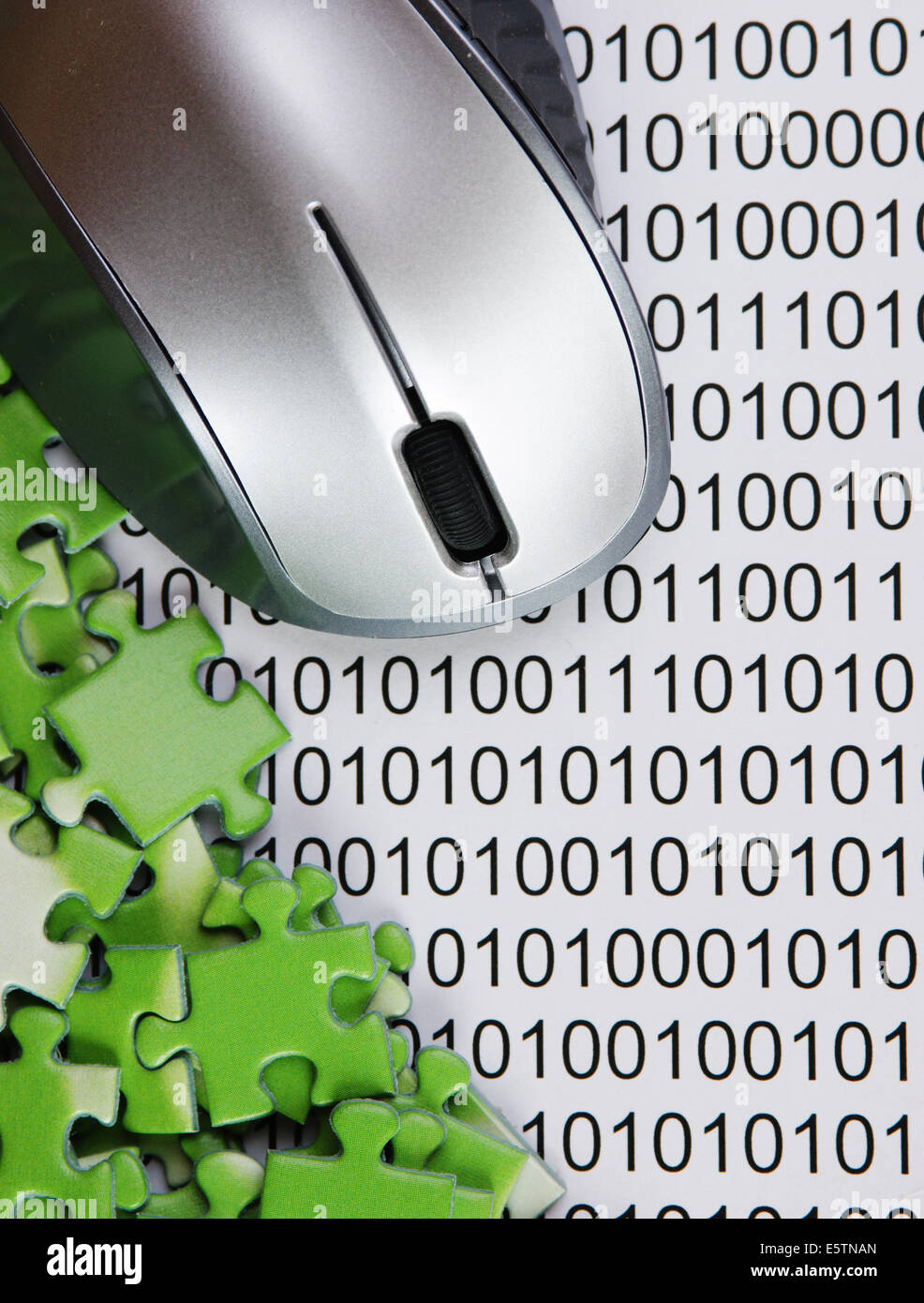 computer mouse and puzzles on a binary code Stock Photo - Alamy