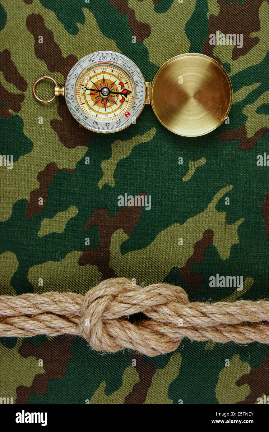 Compass and rope on a camouflage background Stock Photo - Alamy