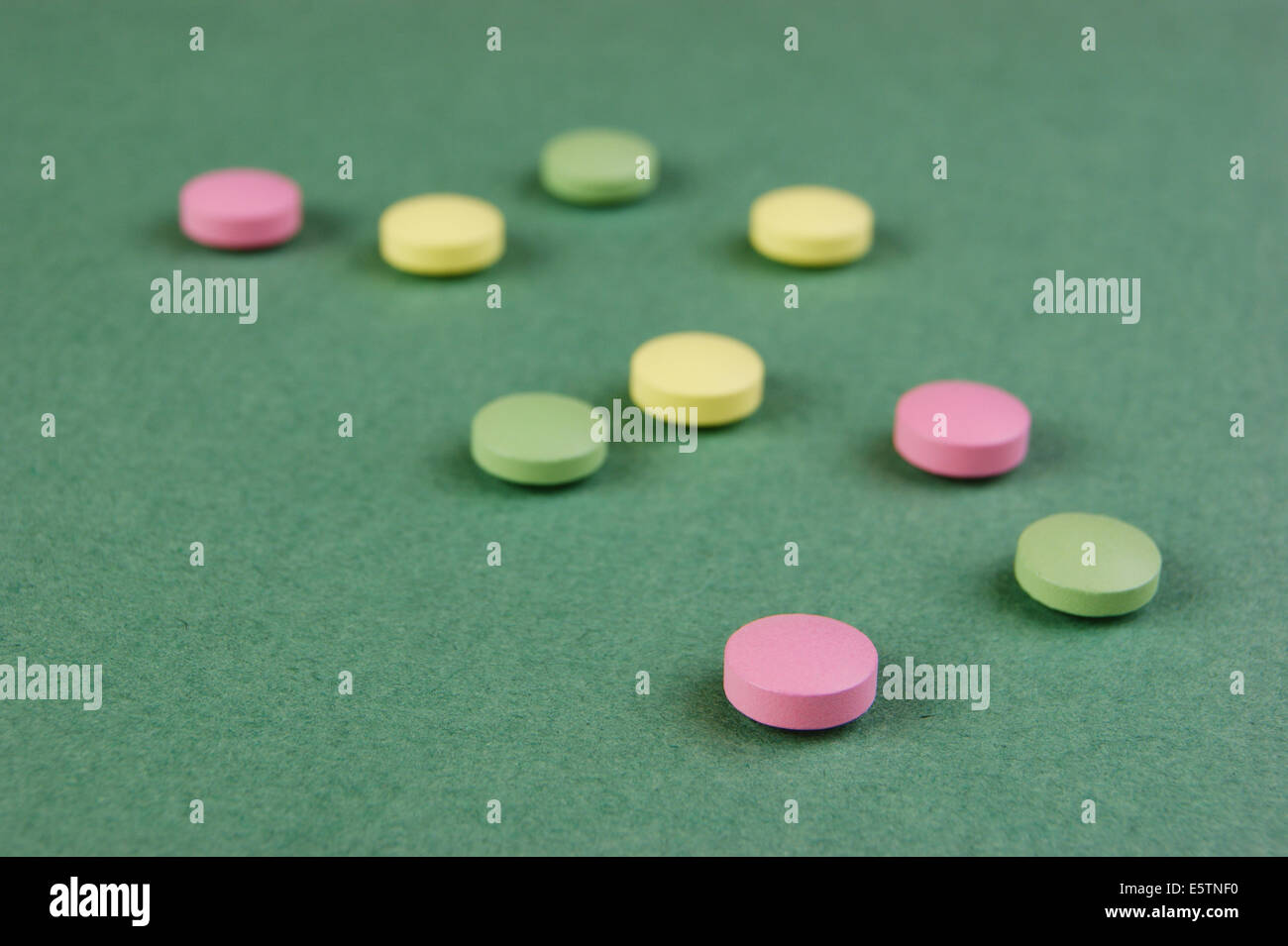 Pills and tablets on a green background Stock Photo - Alamy