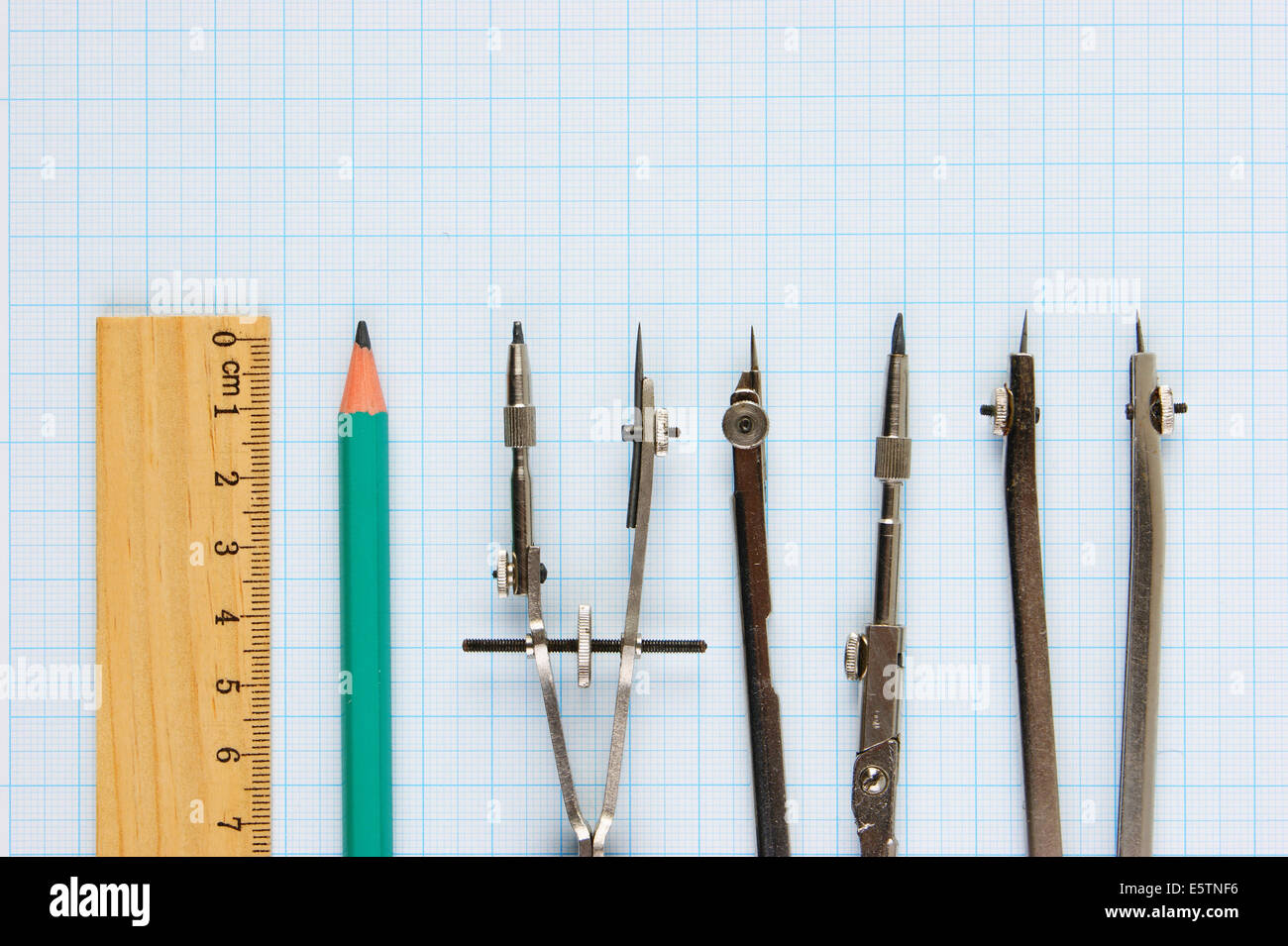Old drawing tools on graph paper Stock Photo - Alamy