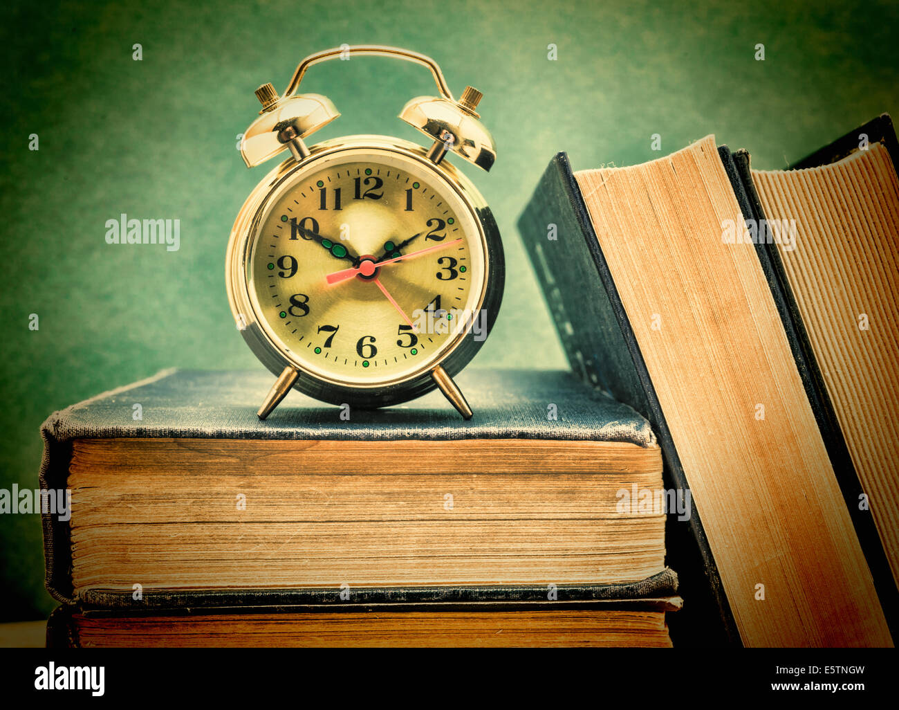 old books and alarm clock Stock Photo - Alamy