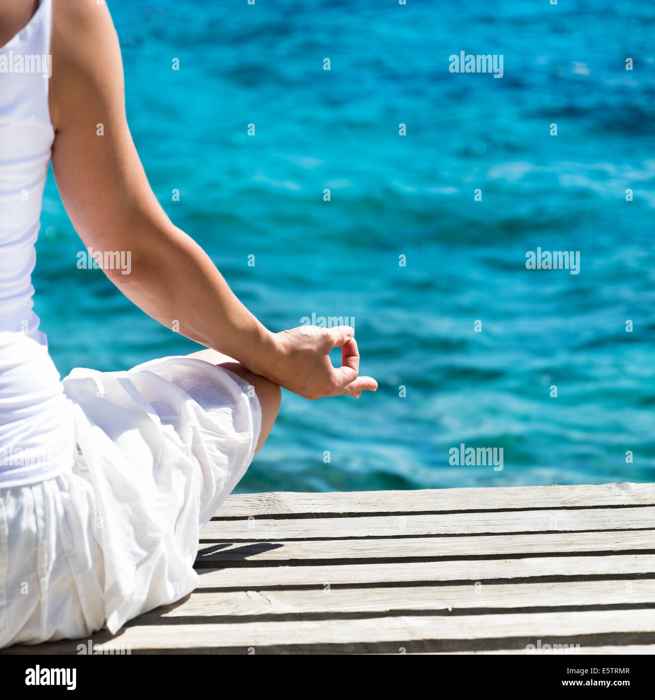 Woman meditating at the sea Stock Photo - Alamy