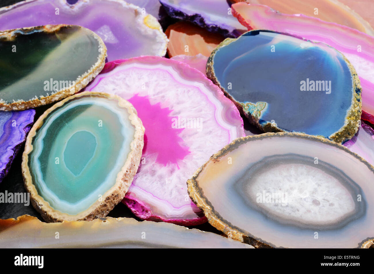 Several slices of dyed geodes in colorful pile Stock Photo - Alamy