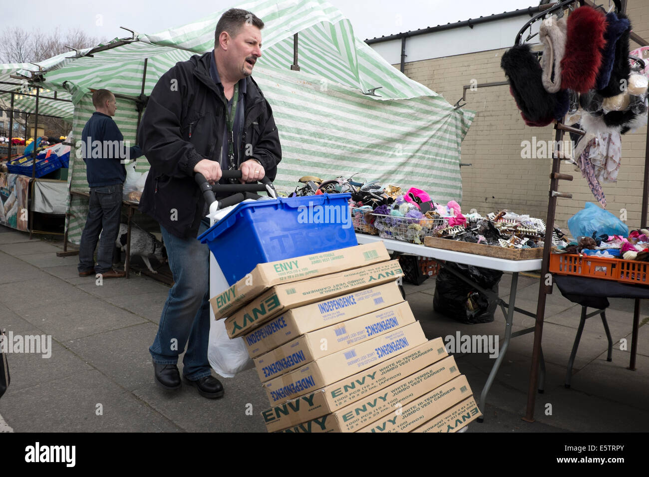 Outdoor Market trader Seller pushing heavy truck barrow Stock Photo - Alamy