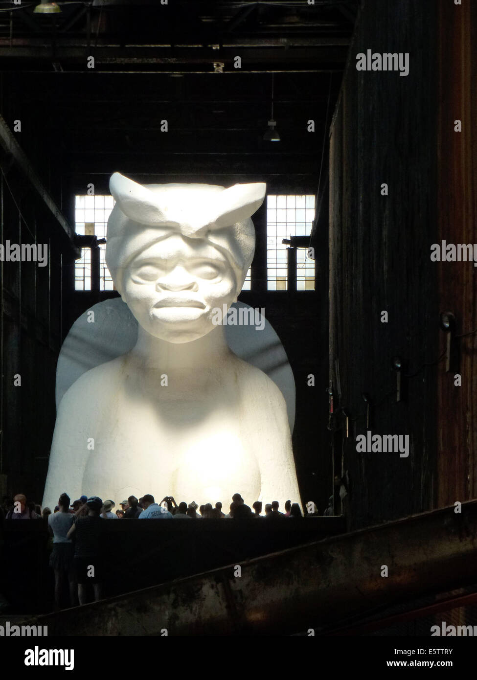 Visitors look at a white sphinx made of sugar by African American ...