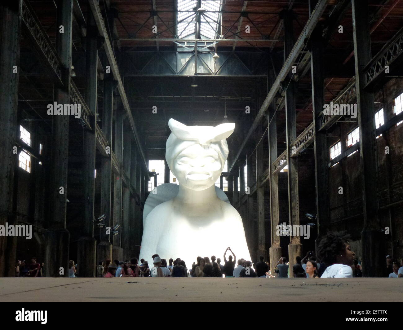 Visitors look at a white sphinx made of sugar by African American ...
