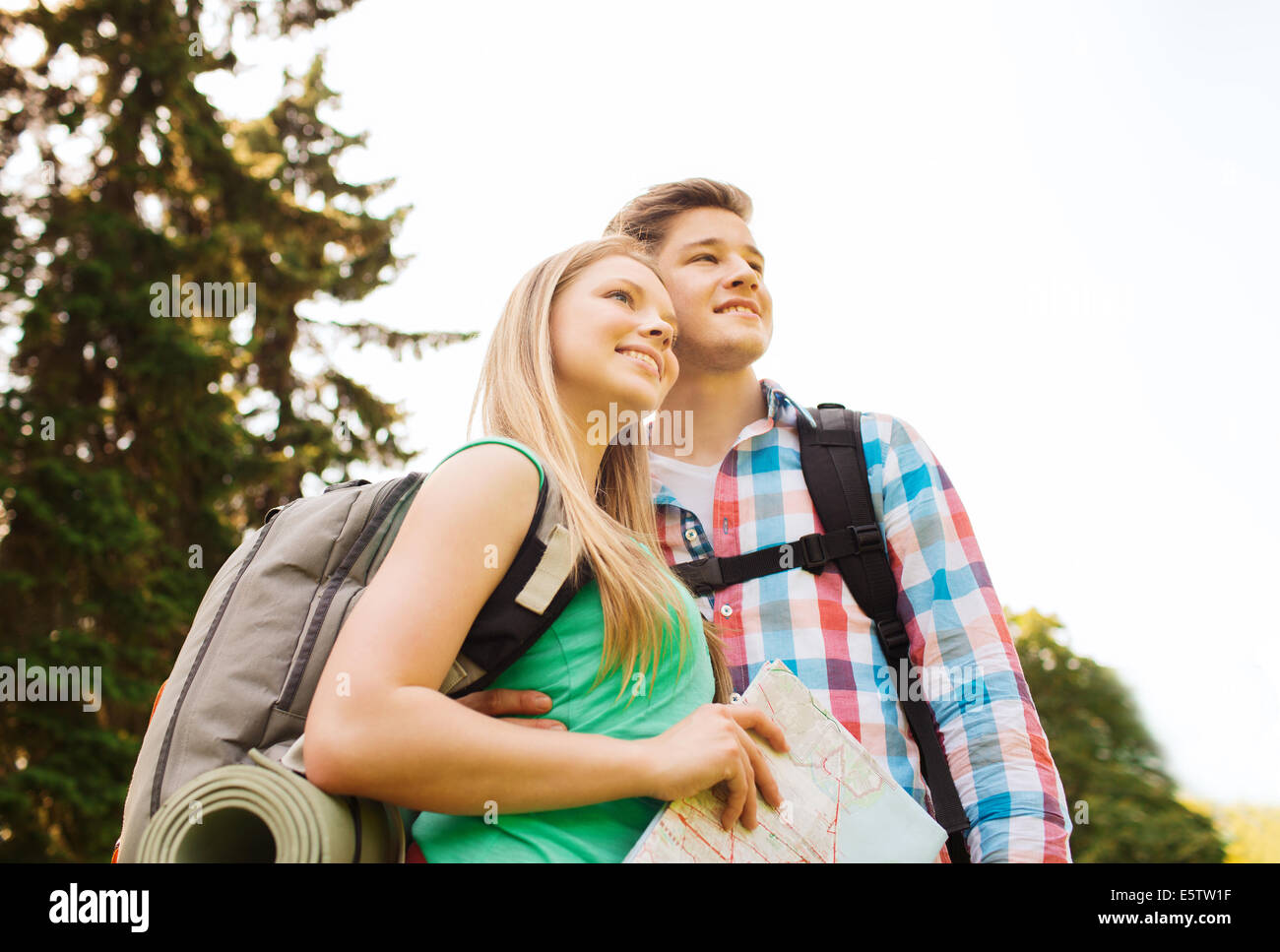 smiling couple with map and backpack in nature Stock Photo - Alamy