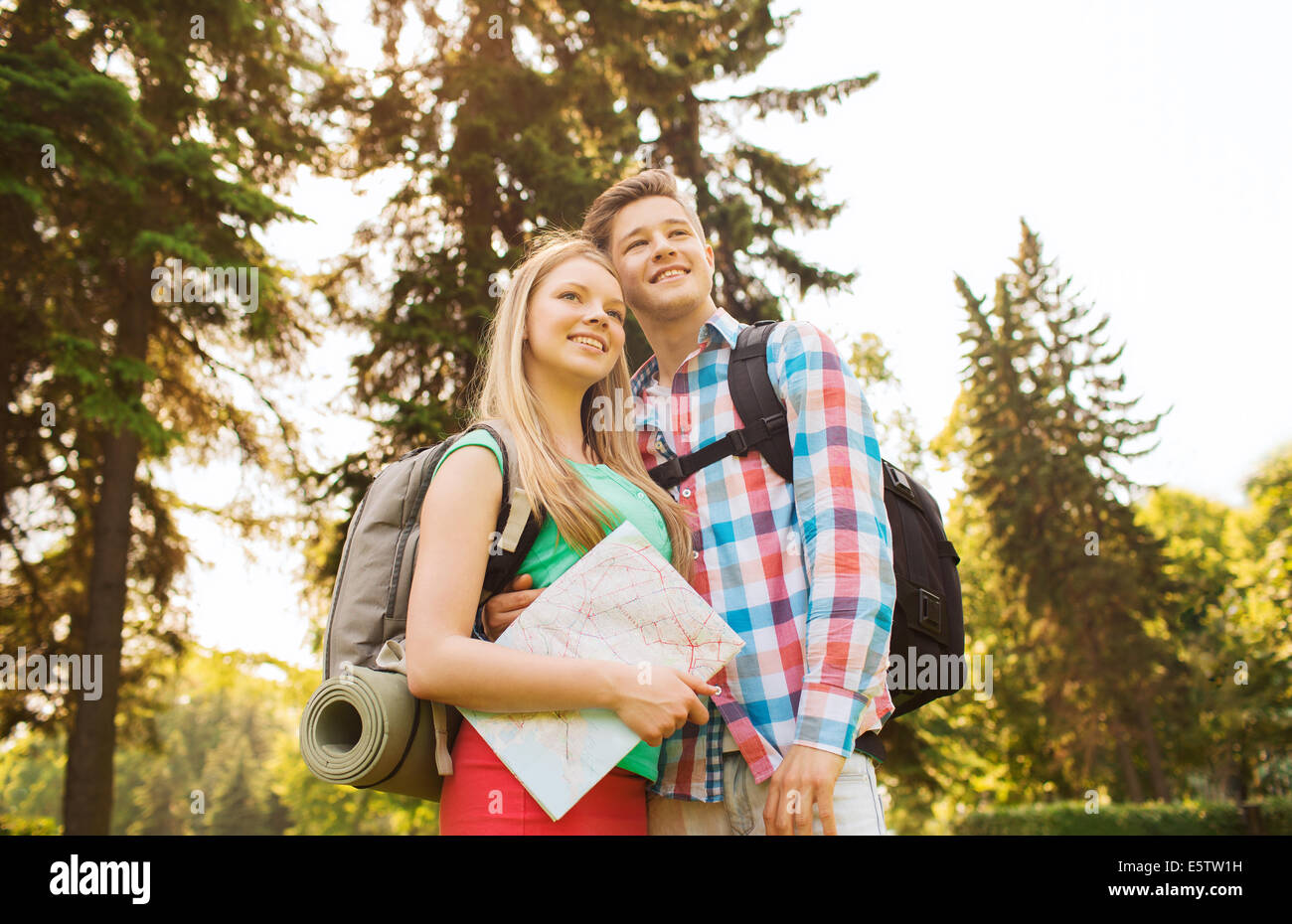 smiling couple with map and backpack in nature Stock Photo - Alamy