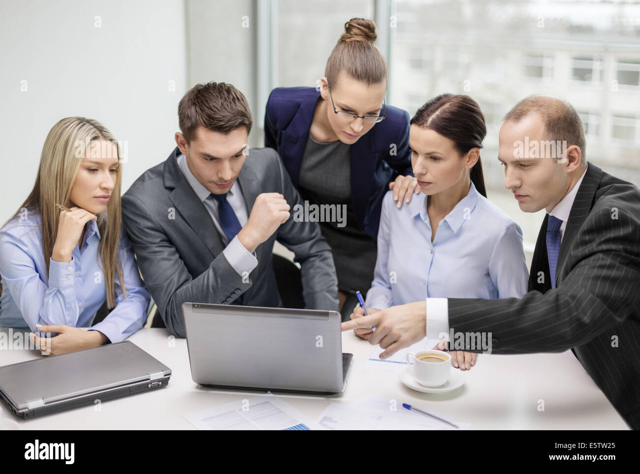 business team with laptop having discussion Stock Photo - Alamy