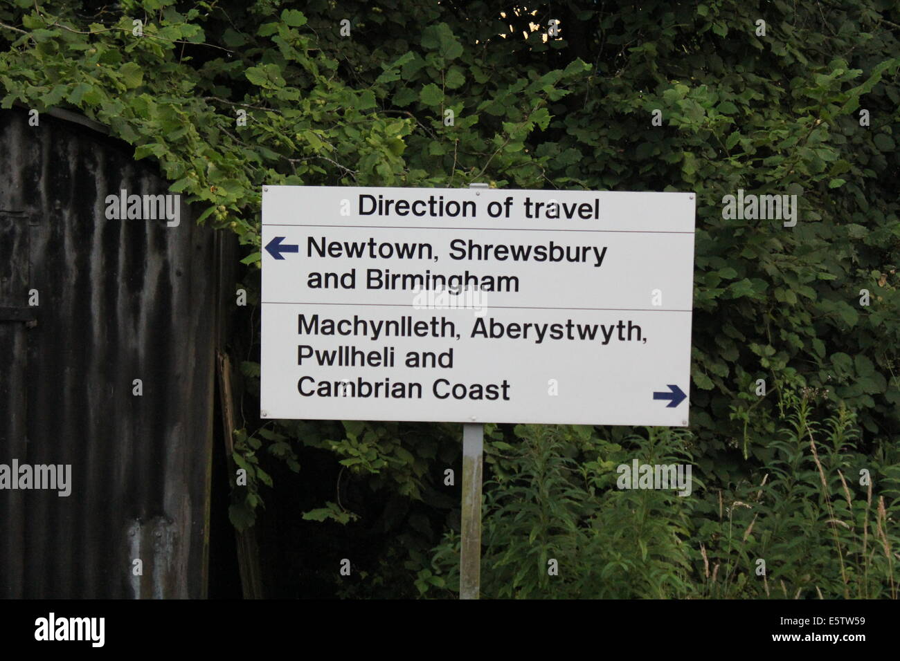 Caersws railway station featuring a direction of travel sign Stock ...