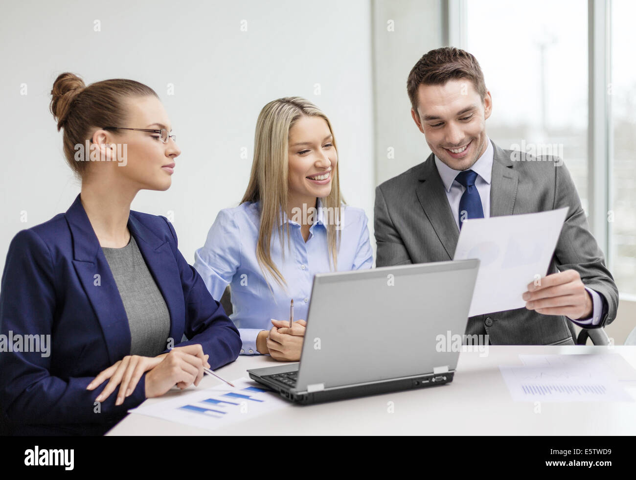 business team with laptop having discussion Stock Photo - Alamy