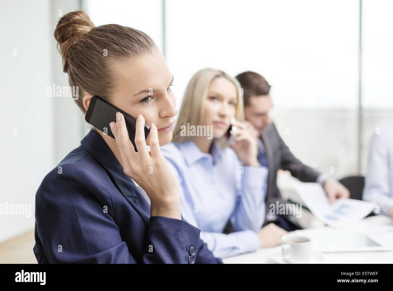 smiling business team with smartphones in office Stock Photo - Alamy