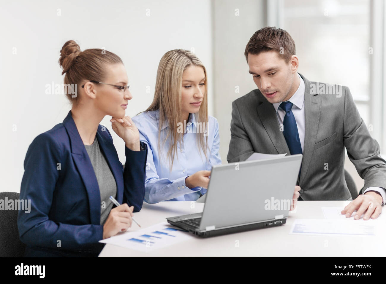 business team with laptop having discussion Stock Photo - Alamy
