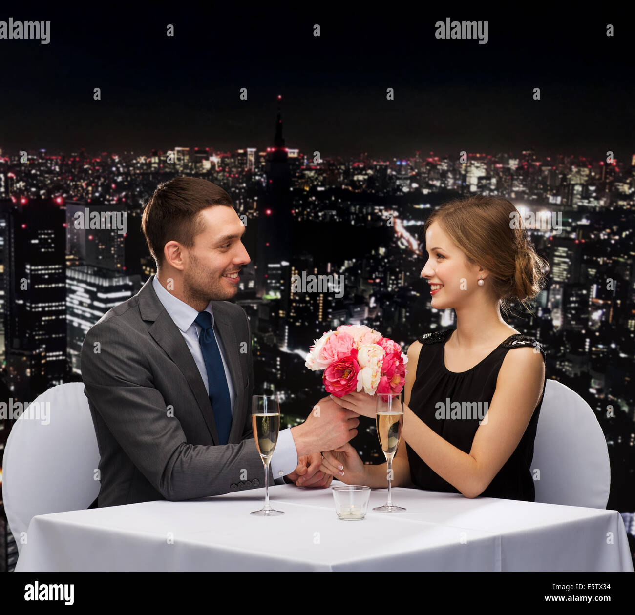 smiling man giving flower bouquet to woman Stock Photo - Alamy