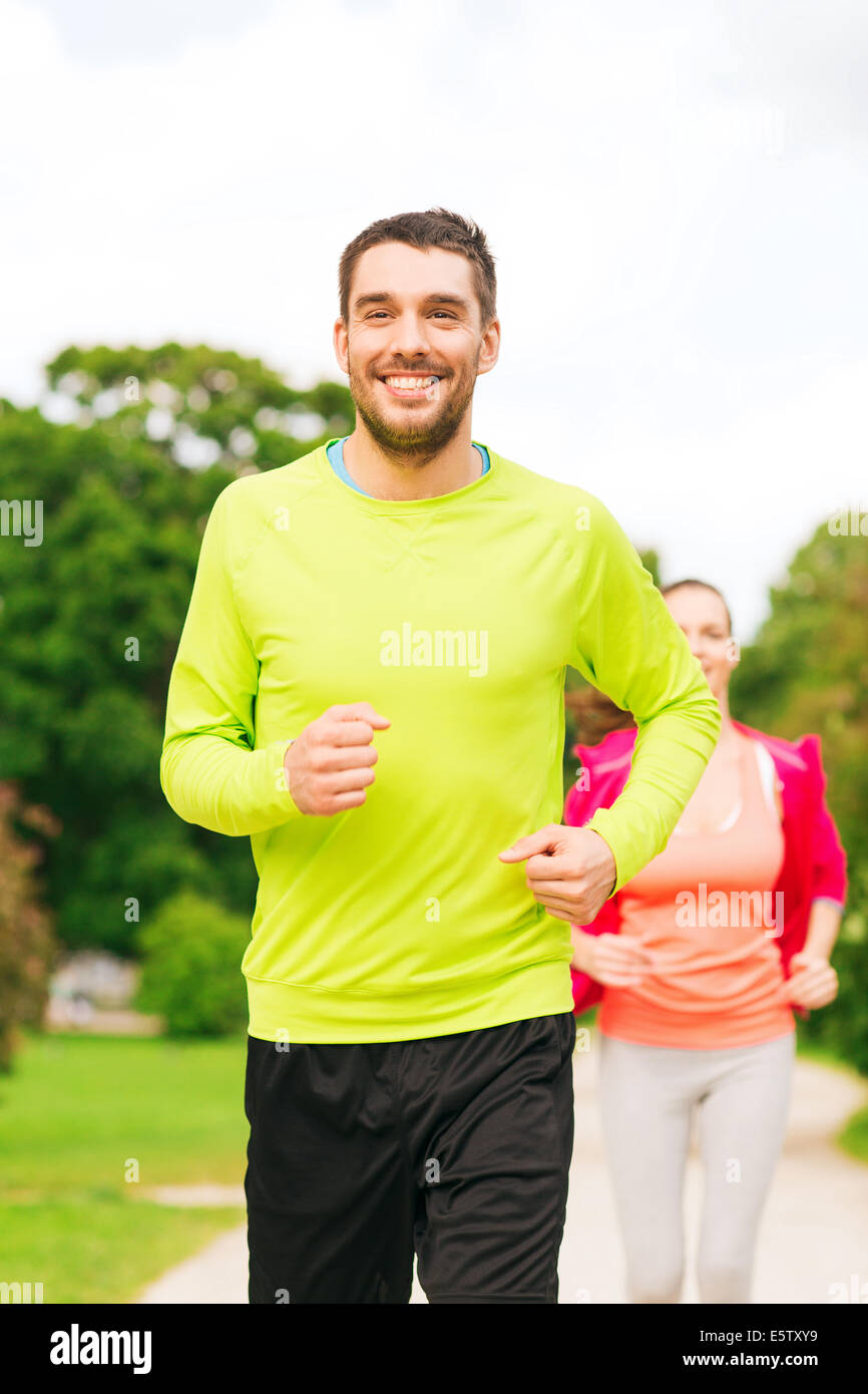 smiling couple running outdoors Stock Photo - Alamy
