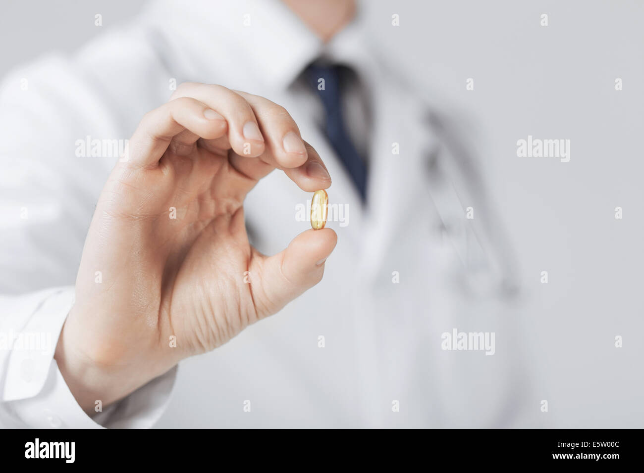 doctor hand showing one capsule Stock Photo - Alamy