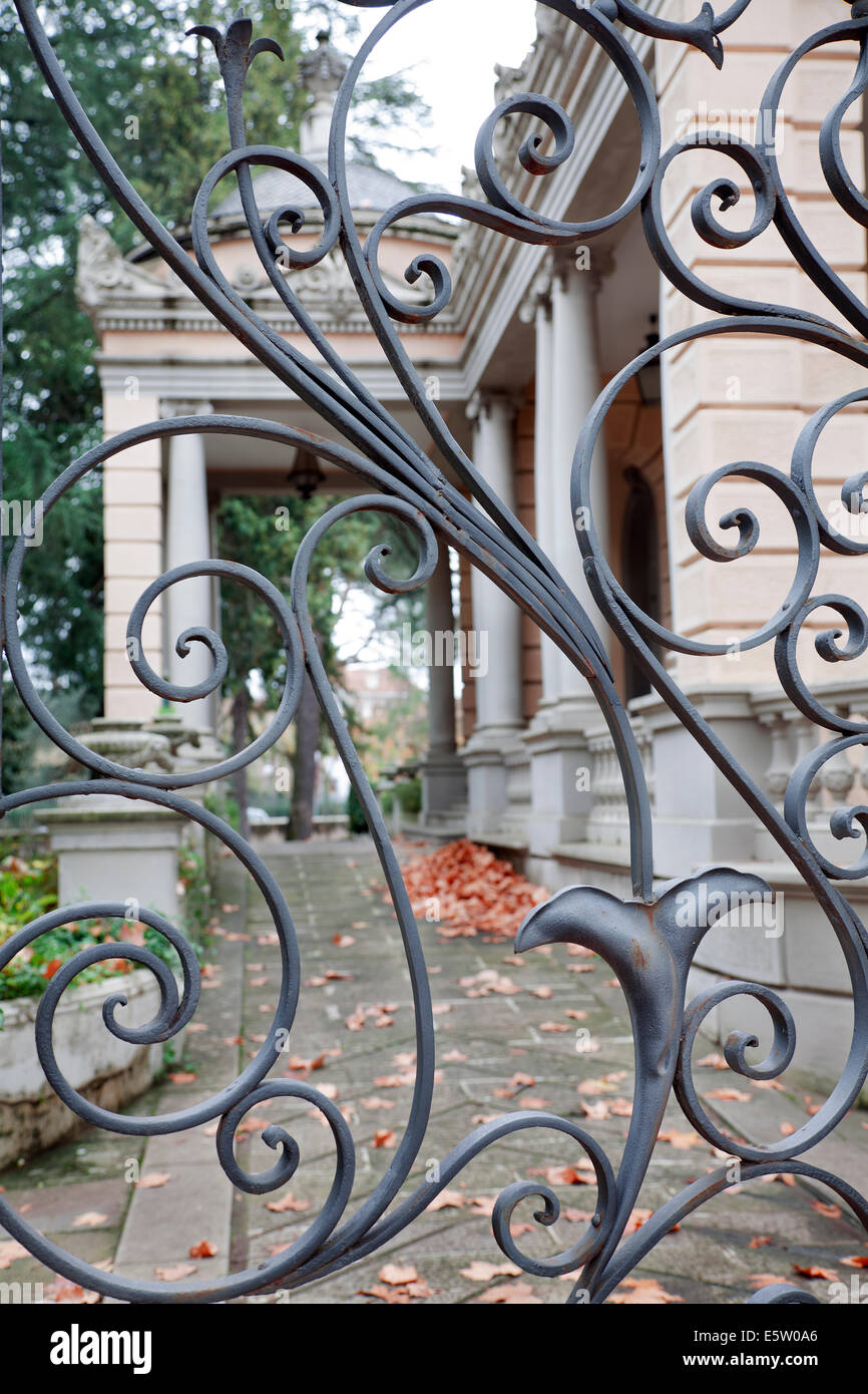 Classic wrought gate with romantic background Stock Photo - Alamy