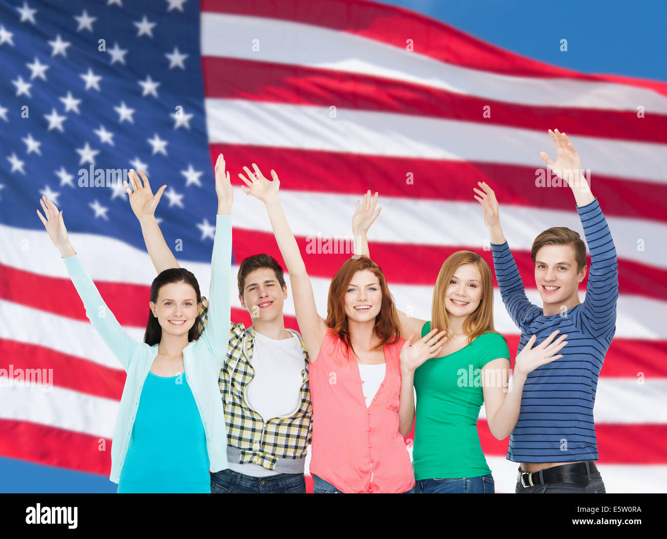 group of smiling students waving hands Stock Photo - Alamy
