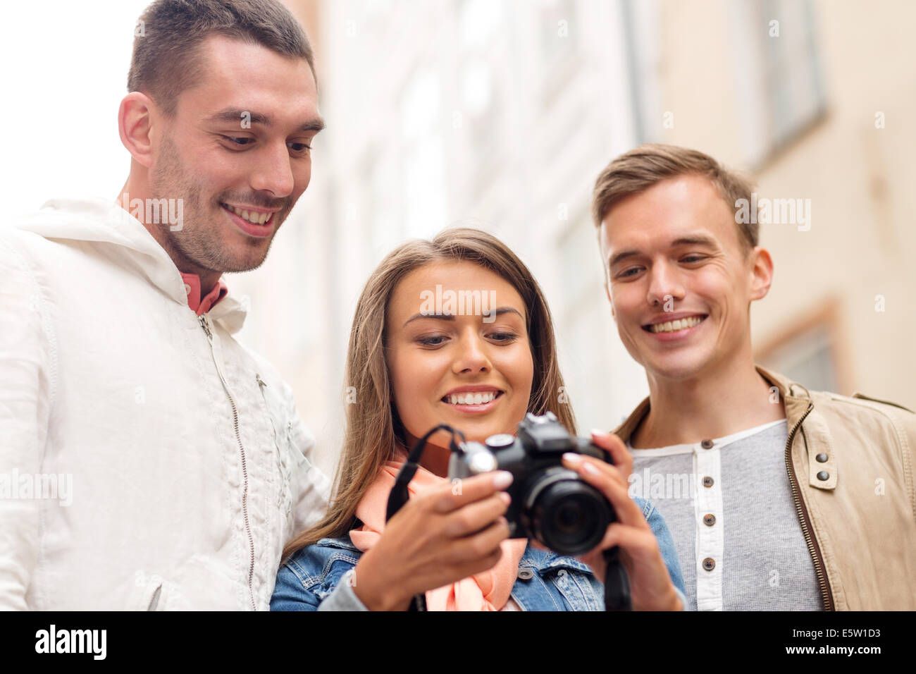 group of smiling friends with digital photocamera Stock Photo - Alamy