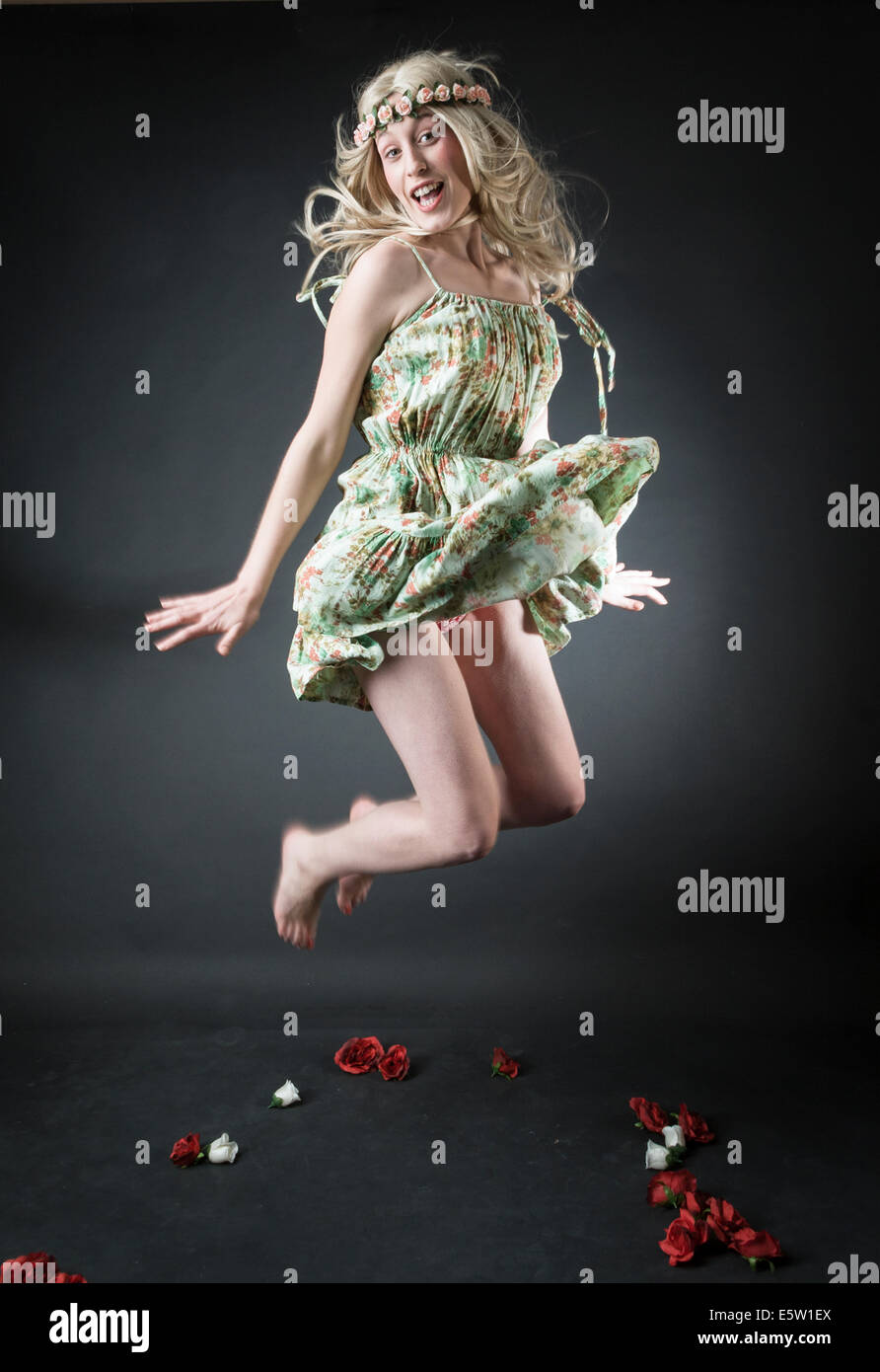 girl jumping for joy on roses Stock Photo - Alamy