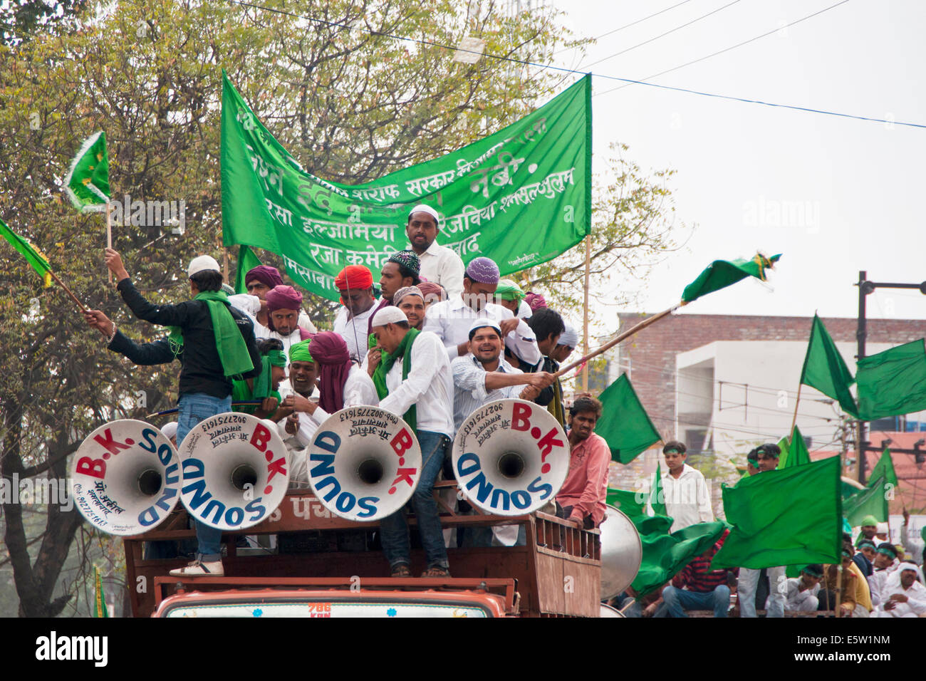 Truck loads of loud celebrating young Muslims. The Islam green ...