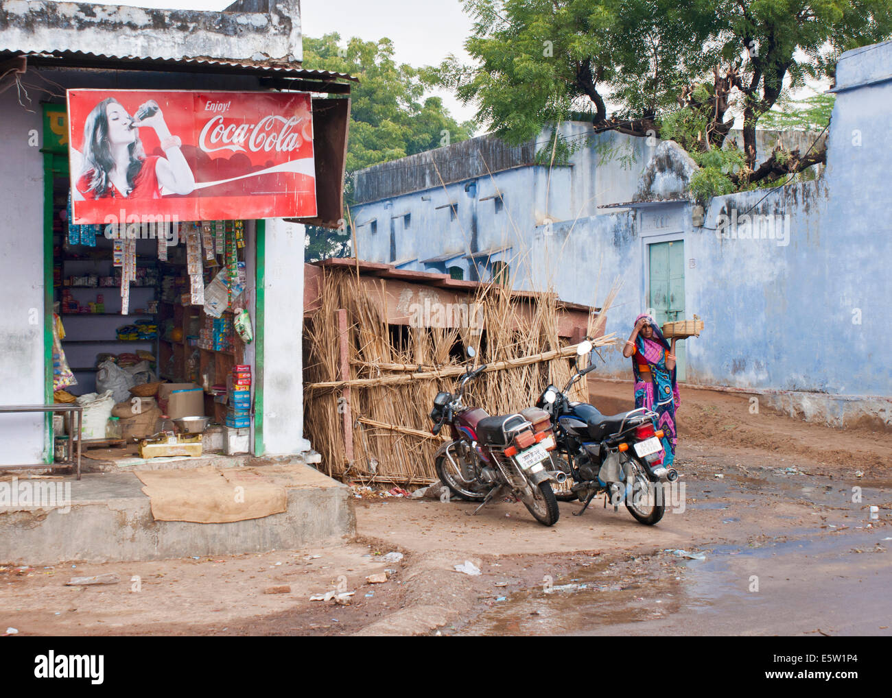 Coca-Cola logo and image of drinking girl are a common sight in India ...