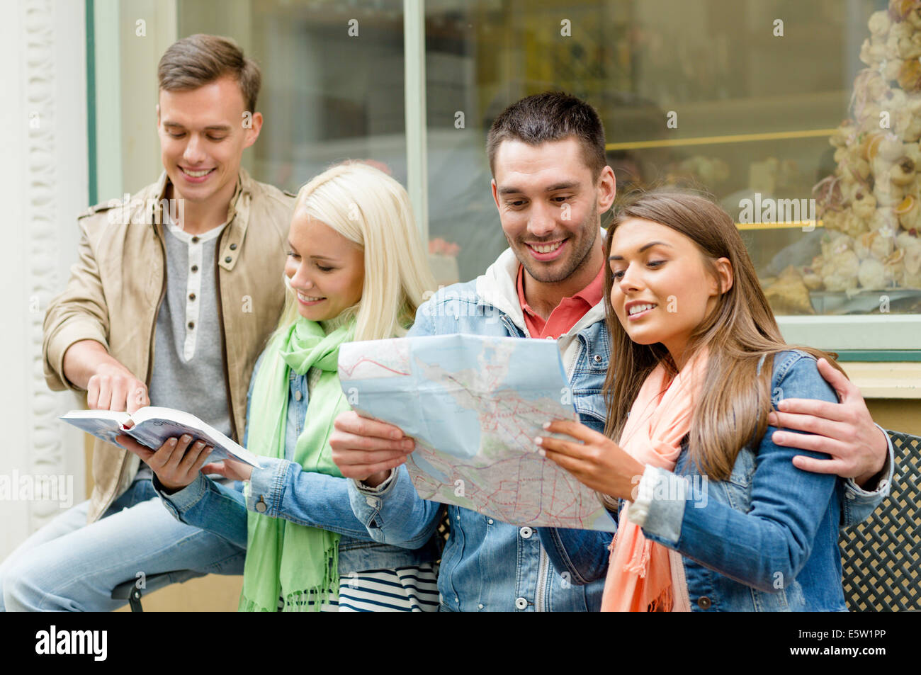 group of friends with guide and map exploring town Stock Photo - Alamy
