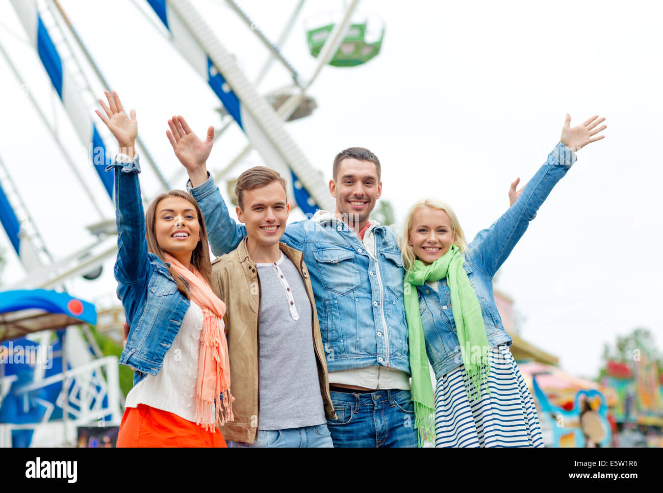 group of smiling friends waving hands Stock Photo - Alamy