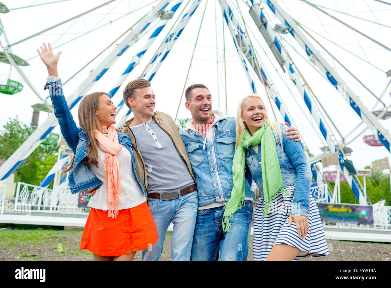 group of smiling friends waving hands Stock Photo - Alamy