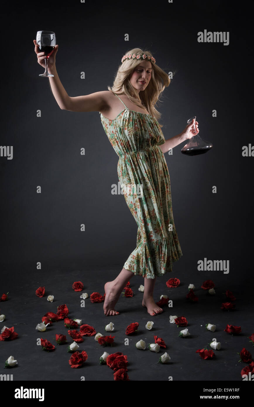 Cheerful girl toasting with a cup and bottle of wine Stock Photo - Alamy