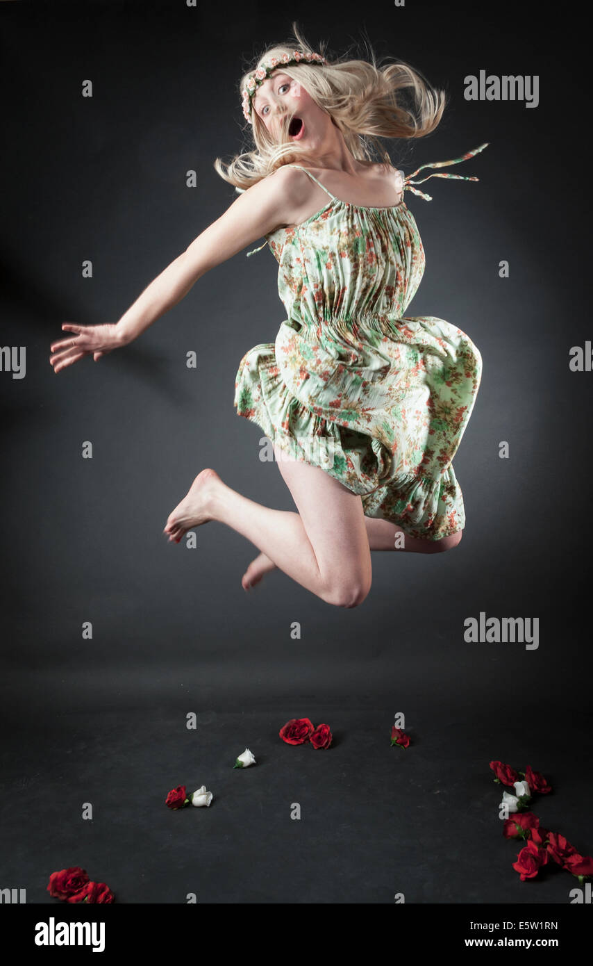 girl jumping for joy on roses Stock Photo - Alamy