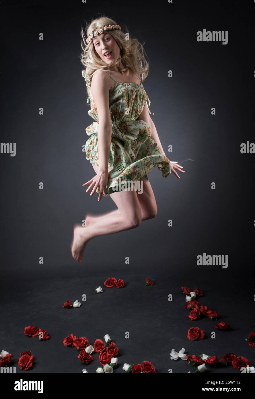 girl jumping for joy on roses Stock Photo - Alamy