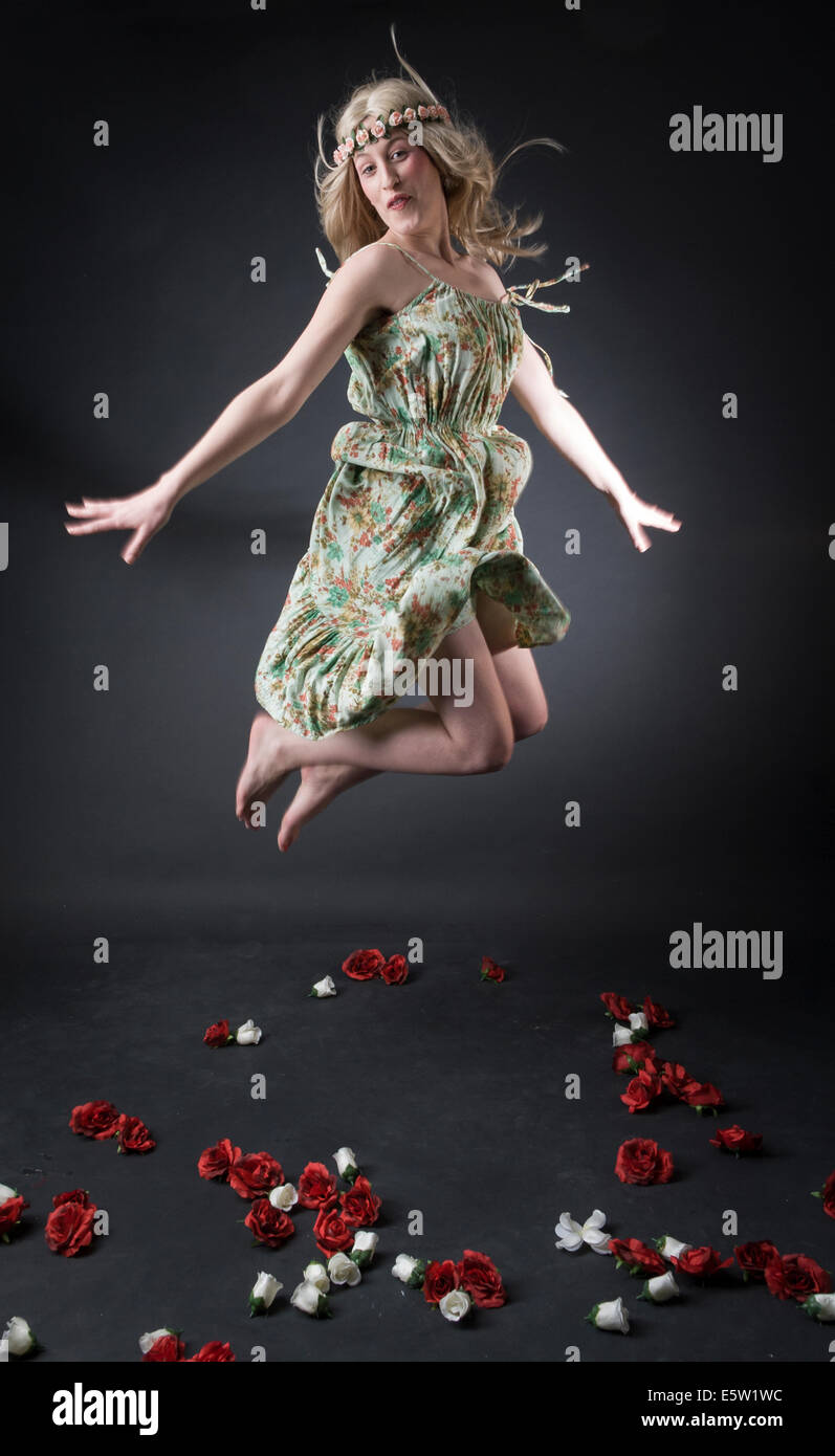 girl jumping for joy on roses Stock Photo - Alamy