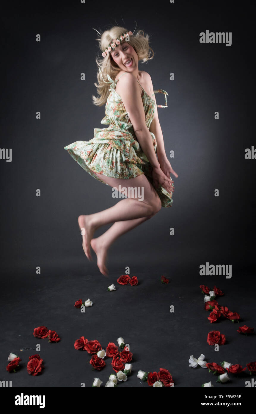 girl jumping for joy on roses Stock Photo - Alamy