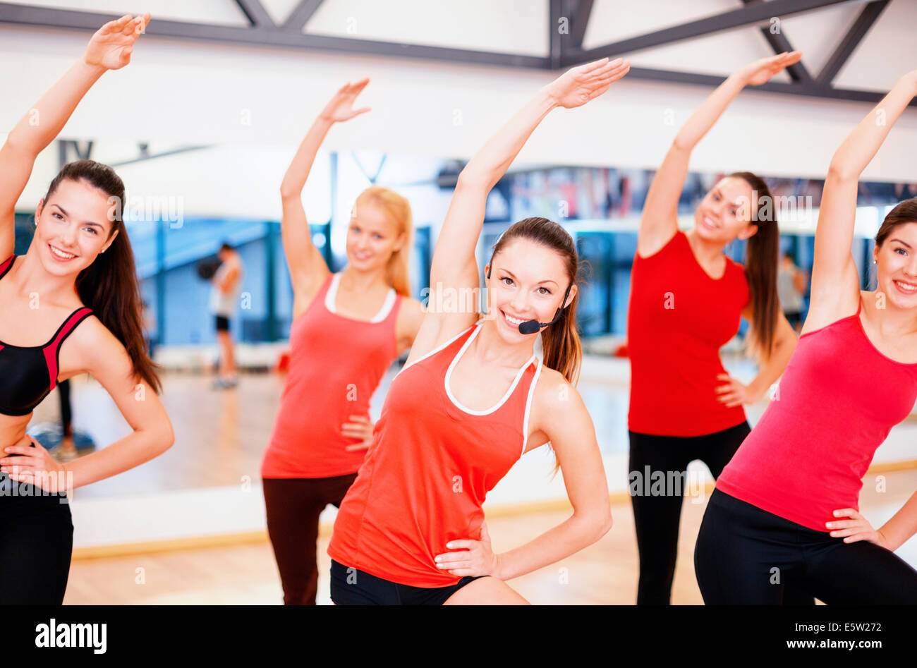 group of smiling people stretching in the gym Stock Photo - Alamy