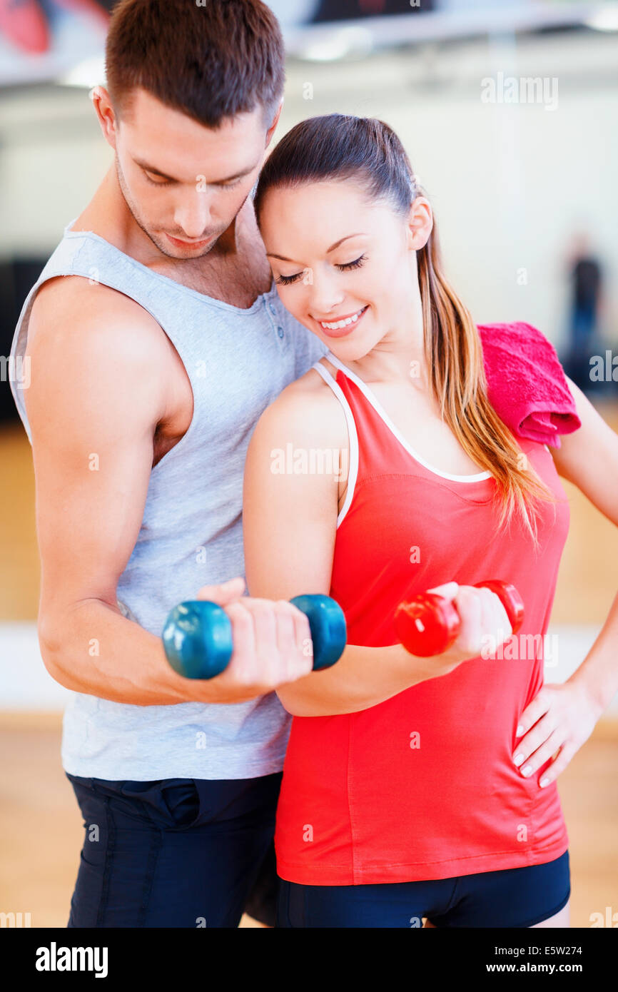 two smiling people working out with dumbbells Stock Photo - Alamy