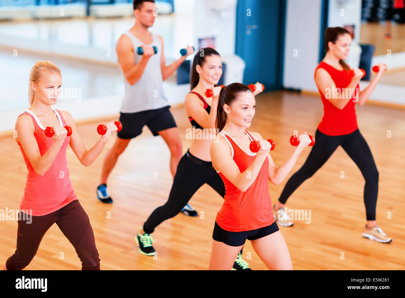 group of smiling people working out with dumbbells Stock Photo - Alamy