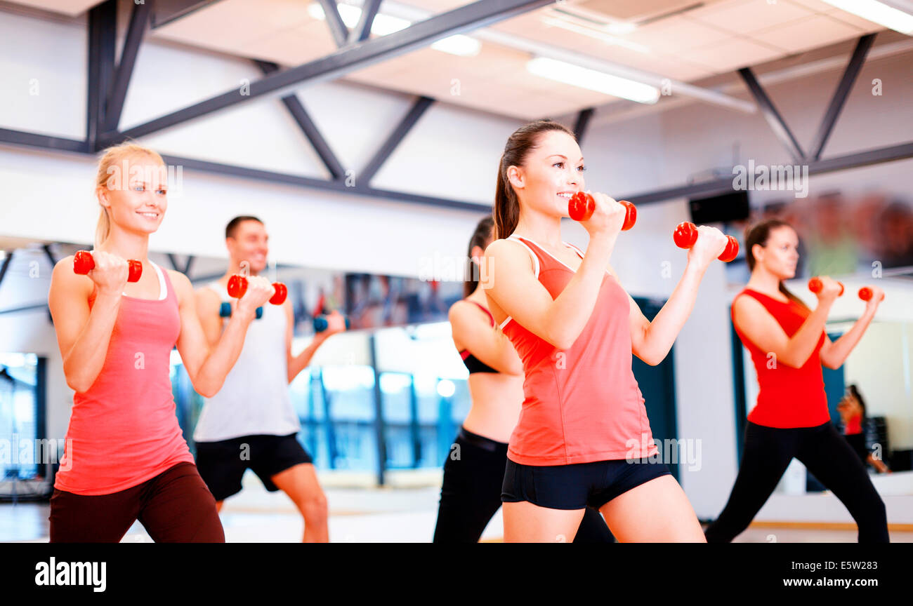 group of smiling people working out with dumbbells Stock Photo - Alamy