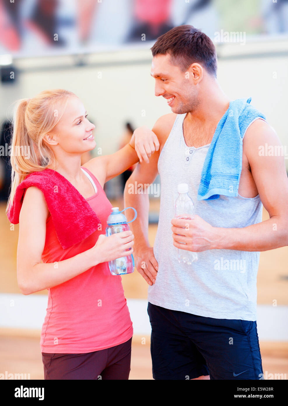 two smiling people in the gym Stock Photo - Alamy