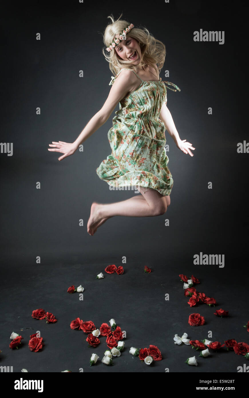 girl jumping for joy on roses Stock Photo - Alamy
