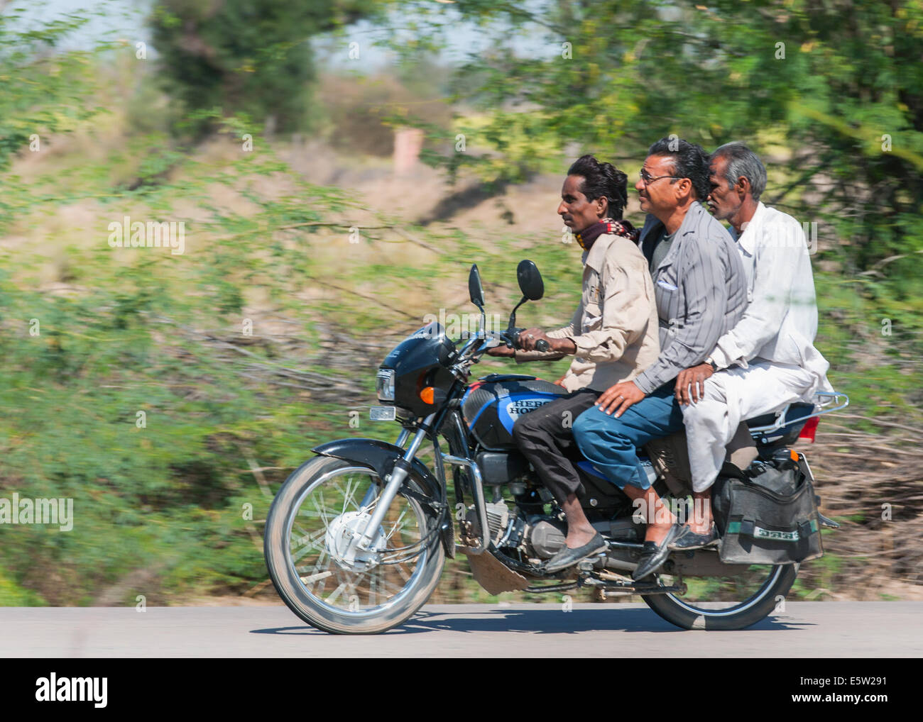 Typical view of three guys, actually three generations, riding on one ...