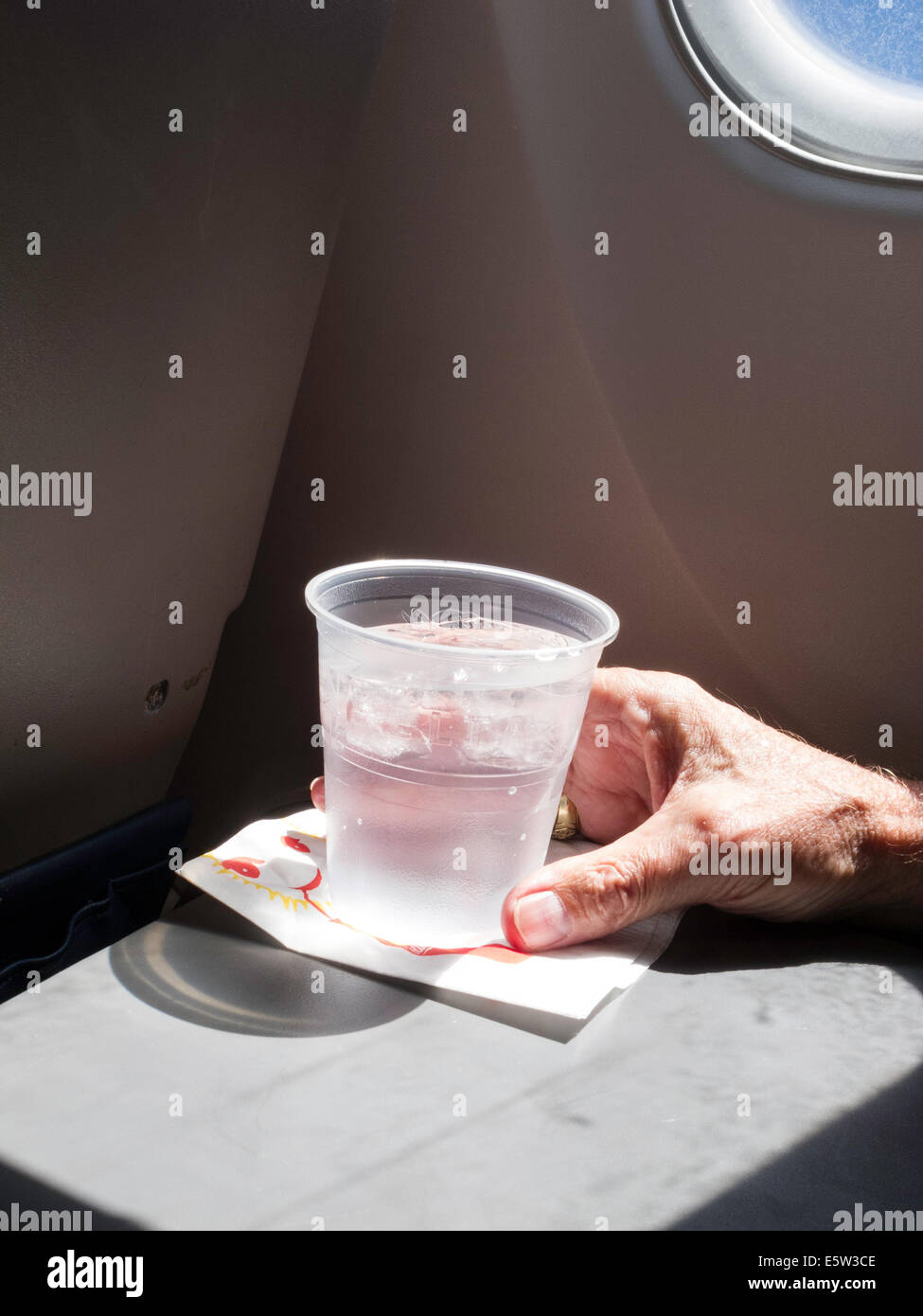 Plastic Cup Filled with Water Aboard Airplane Tray Table, USA Stock ...